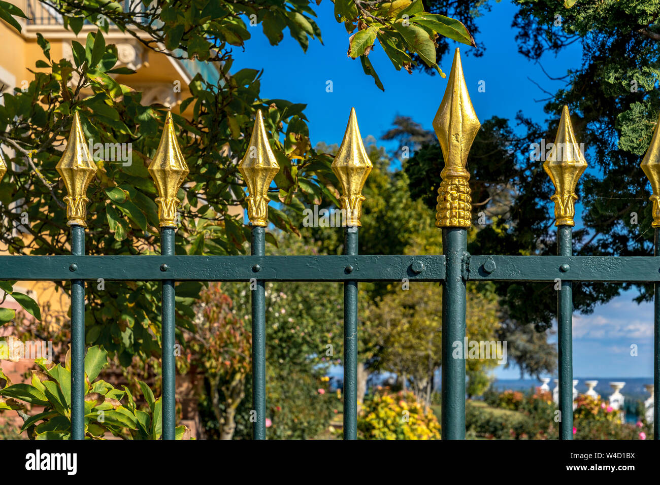 Solid iron fence with gold-plated lance tips Stock Photo - Alamy