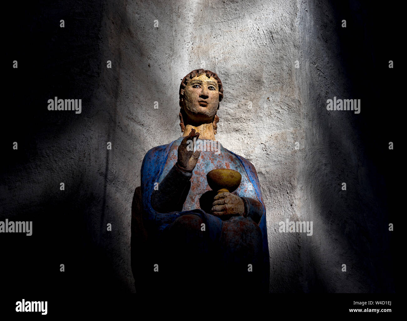 Blessing ancient saint figure with blue eyes with a chalice Stock Photo ...