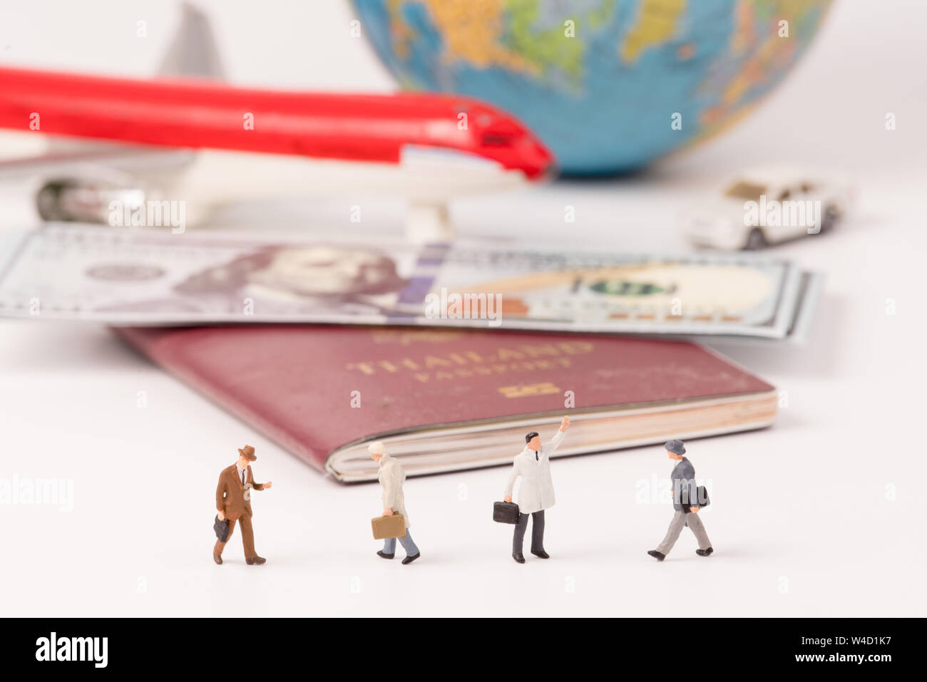 Miniature figurines of traveller with map ,airplane,car ,dollar ...