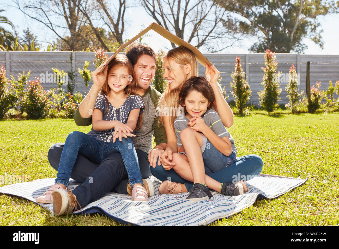 Family and children with a roof over their heads as a concept for home ...