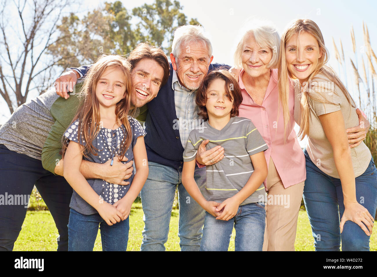 Happy extended family with children and grandparents in the summer in ...