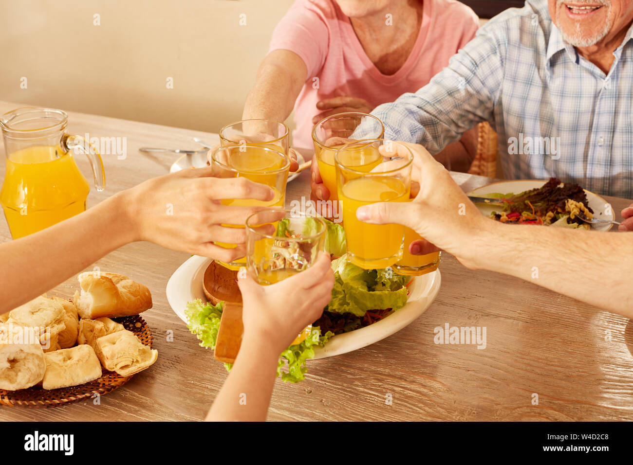 Family drinks fresh orange juice for healthy lunch or dinner Stock ...
