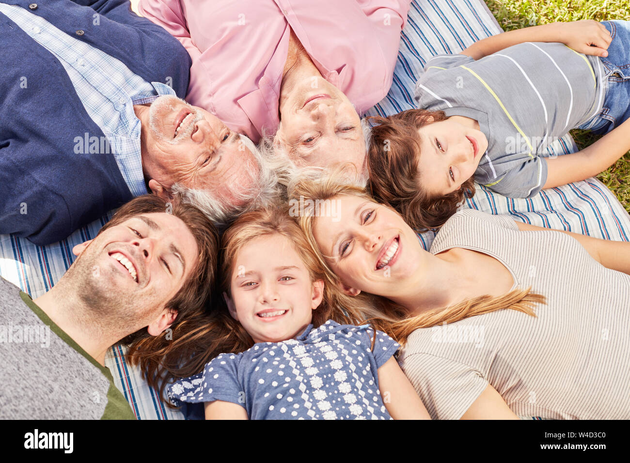 Happy extended family with three generations is head to head in the ...