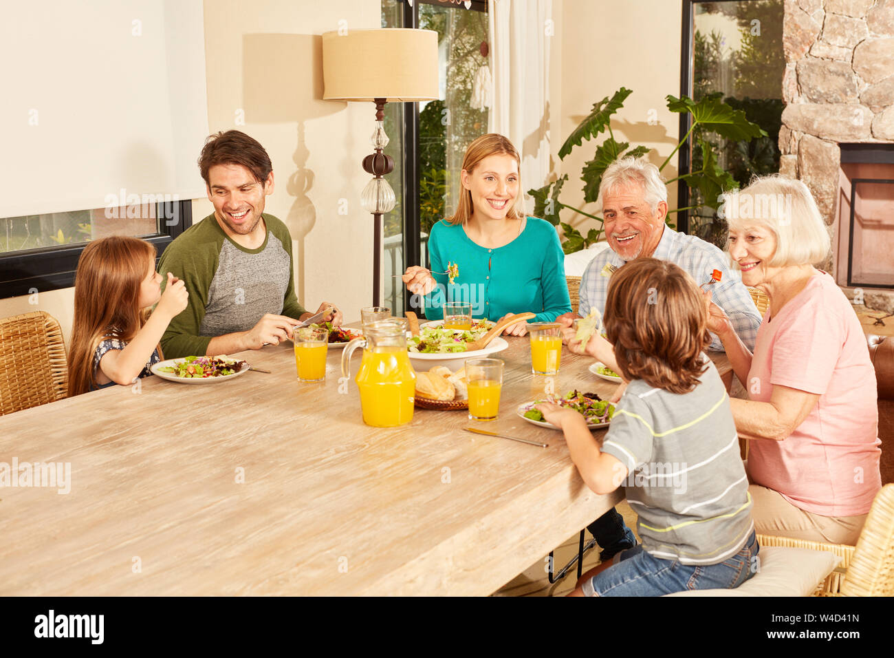 Family of three generations having lunch together at the big dining ...
