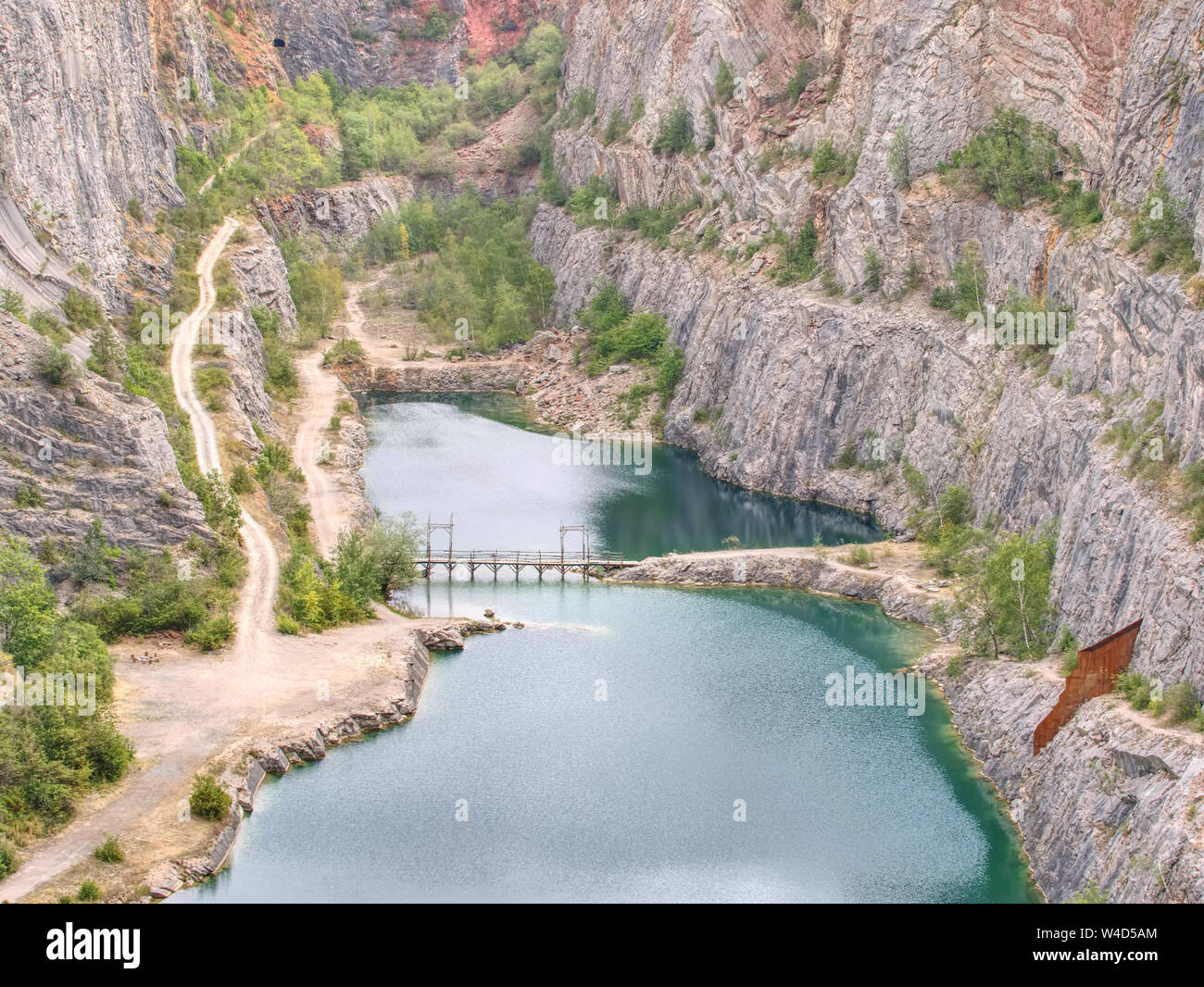 Great old quarry for dolomite mining. Blue lagoon in middle with wooden ...