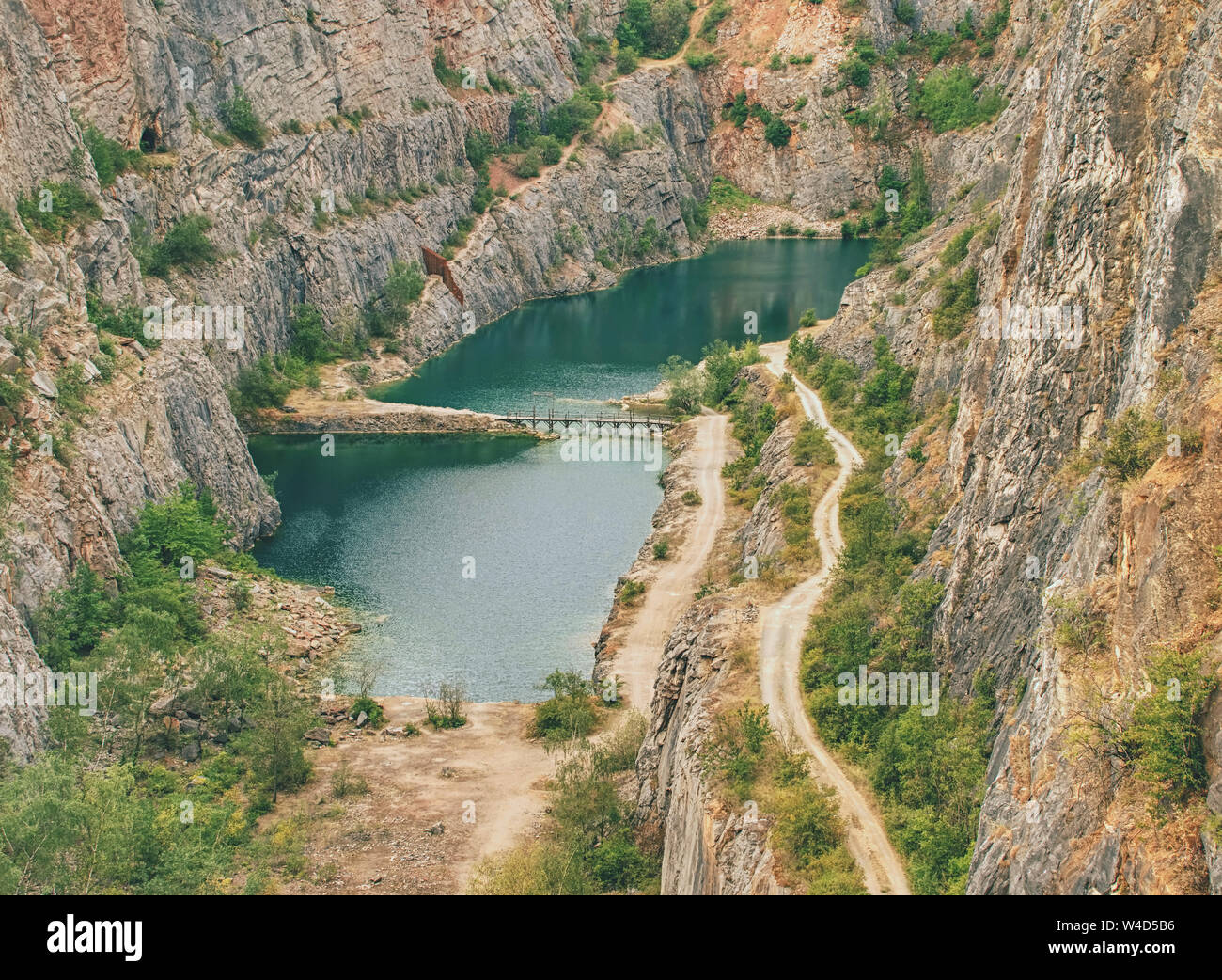 Great old quarry for dolomite mining. Blue lagoon in middle with wooden ...