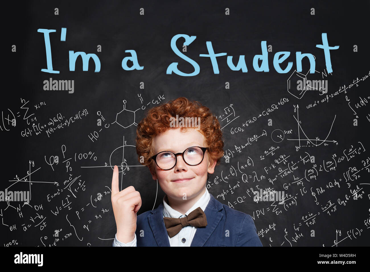 Smart student boy pointing finger on chalkboard background with I'm ...