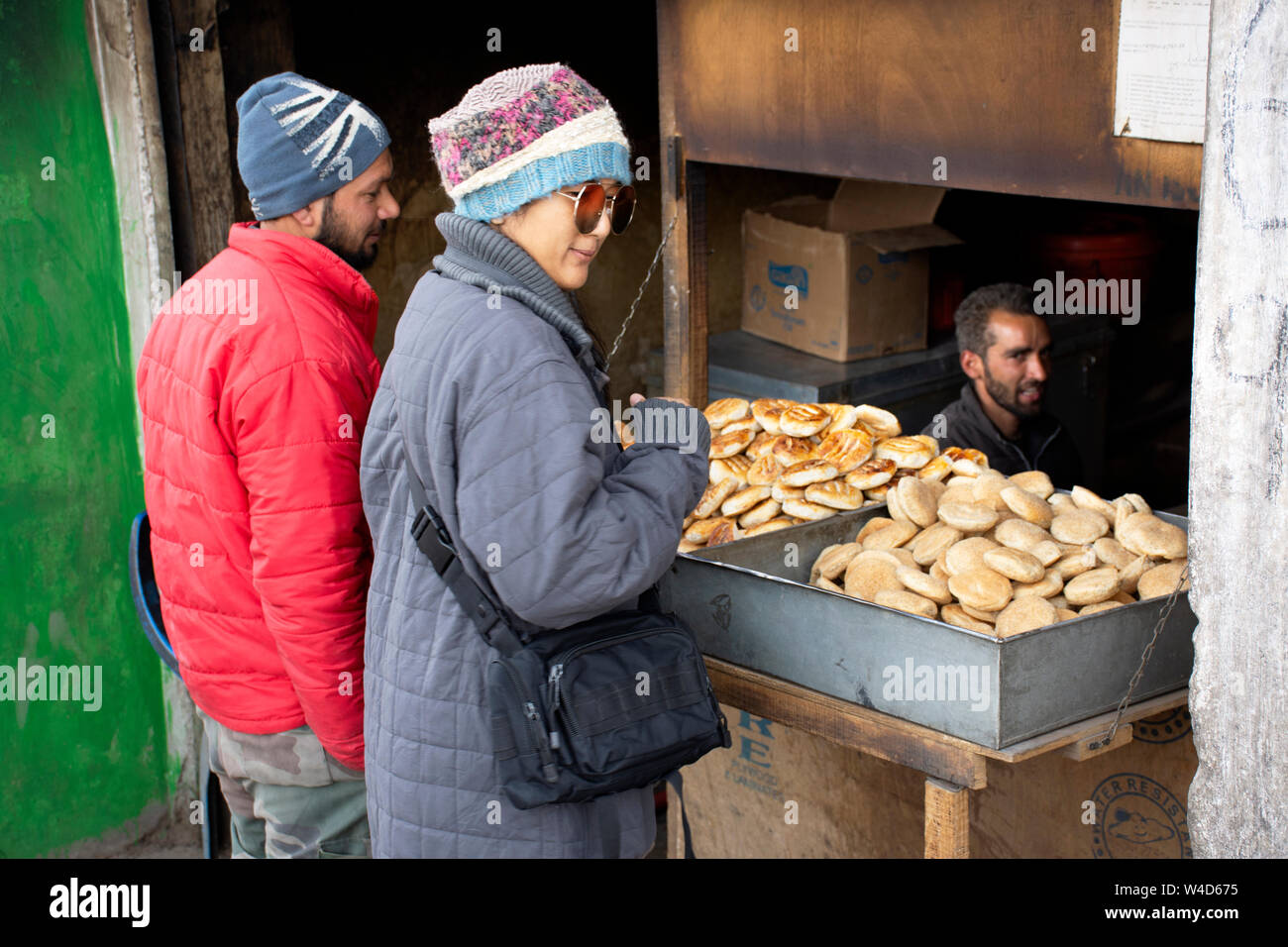 Indian and tibetan people sale and buy bread from local shop in bazaar ...