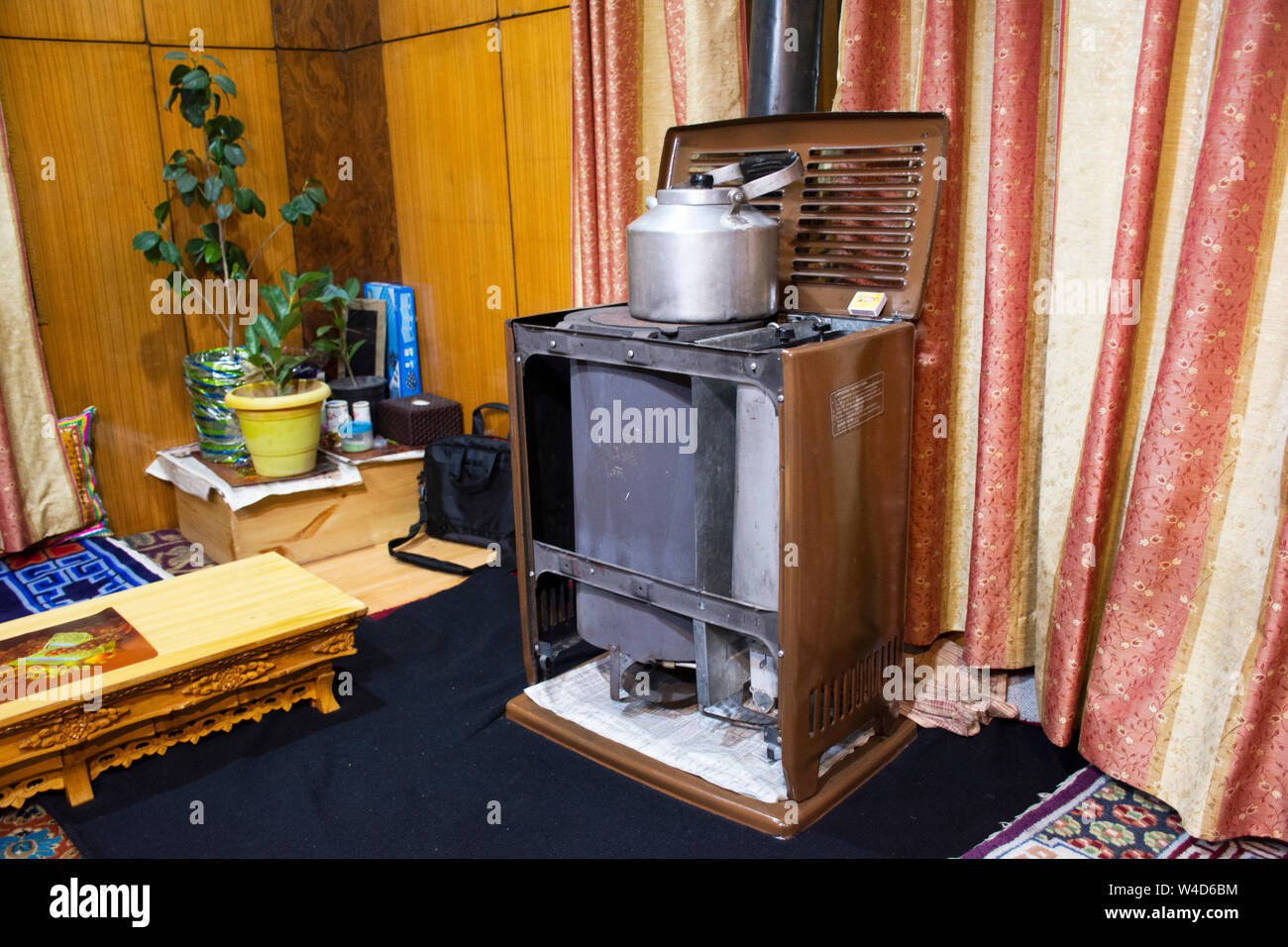 Classic retro stove heater of Indian and tibetan people in living room ...
