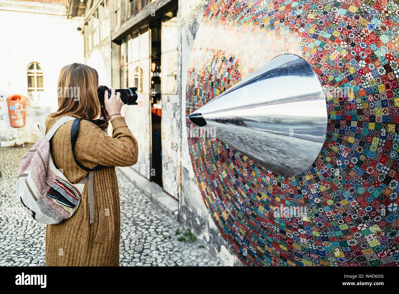 Woman photographing a conical artwork Stock Photo - Alamy