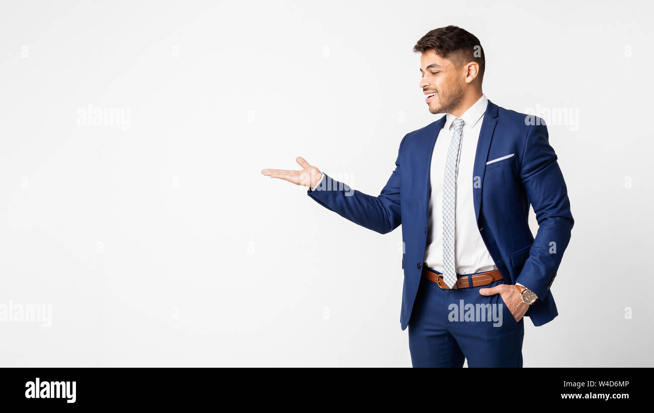 Young businessman presenting something hi-res stock photography and ...