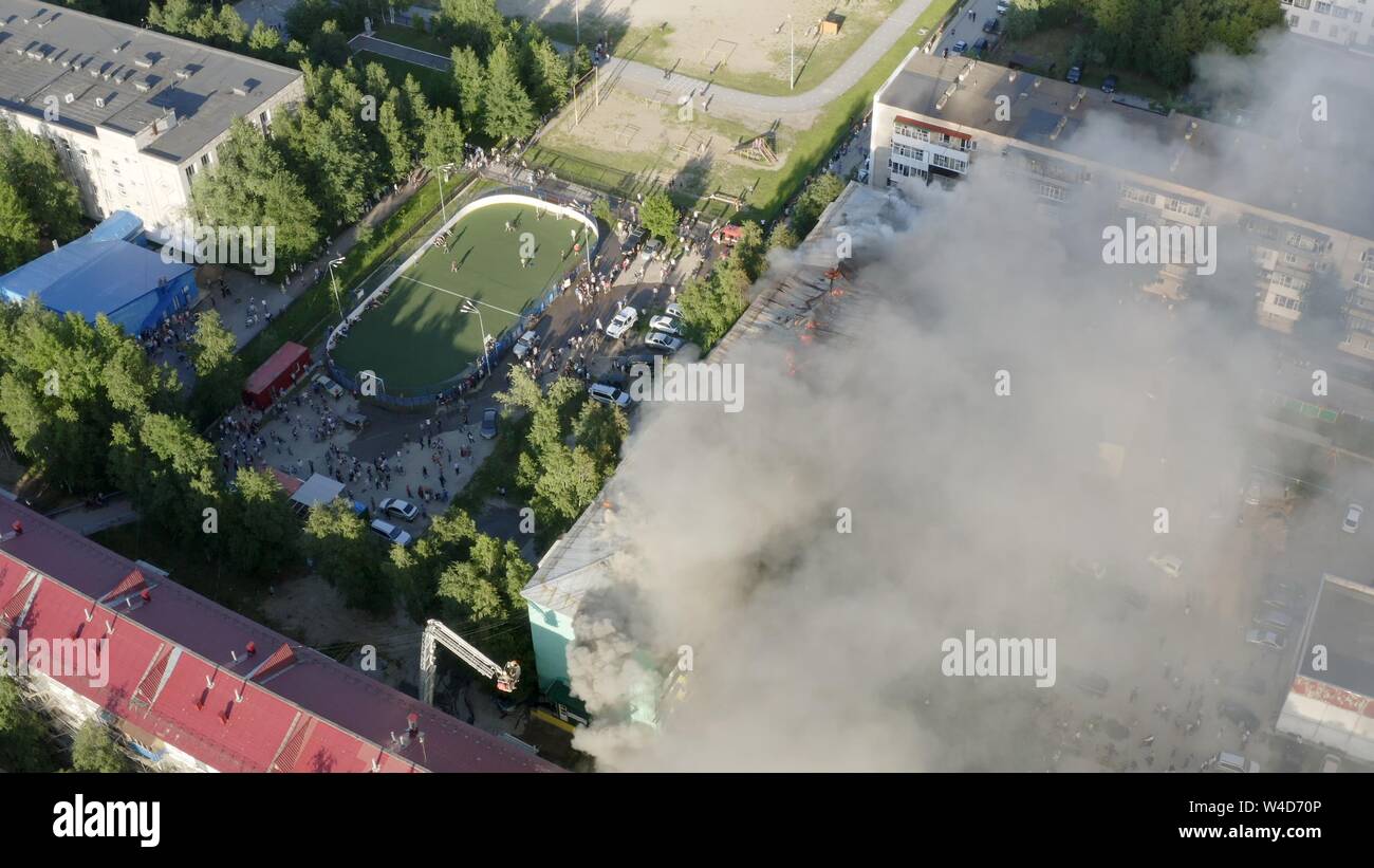 Burning roof of a residential high-rise building, clouds of smoke from ...