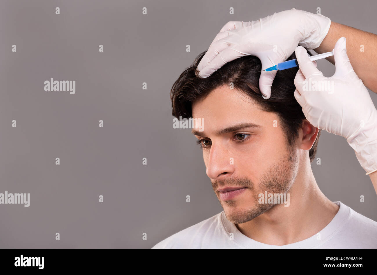 Man with hair loss problem receiving injection in head Stock Photo - Alamy