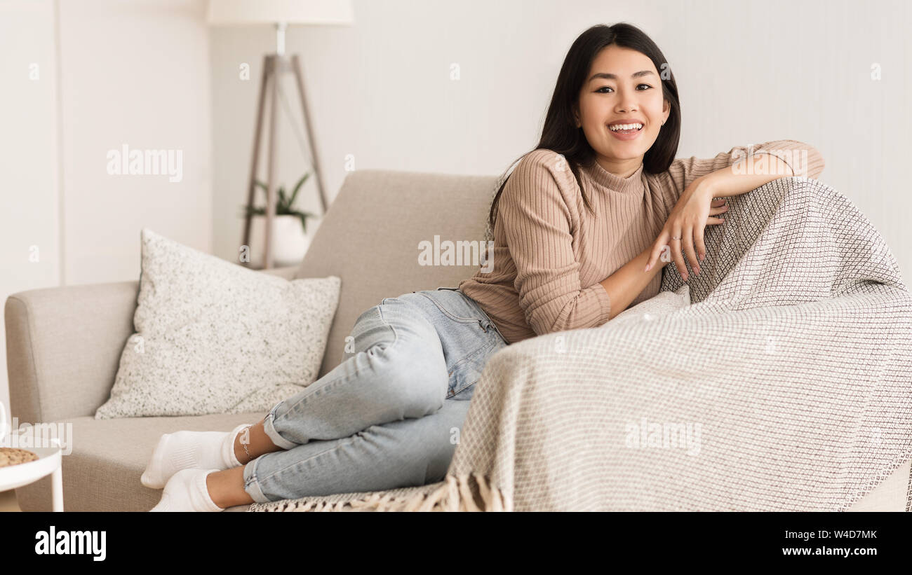 Student Girl Resting on Sofa and Looking at Camera Stock Photo - Alamy