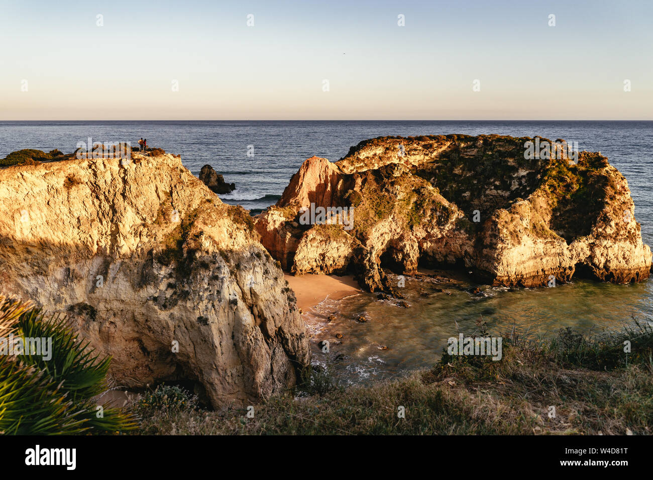 A secluded sandy beach and eroded sea arch Stock Photo - Alamy