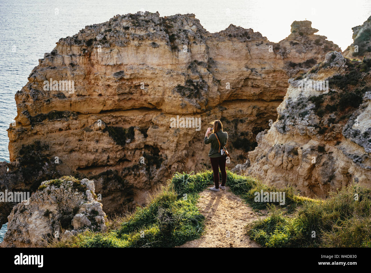 Male tourist photographing limestone cliffs Stock Photo - Alamy