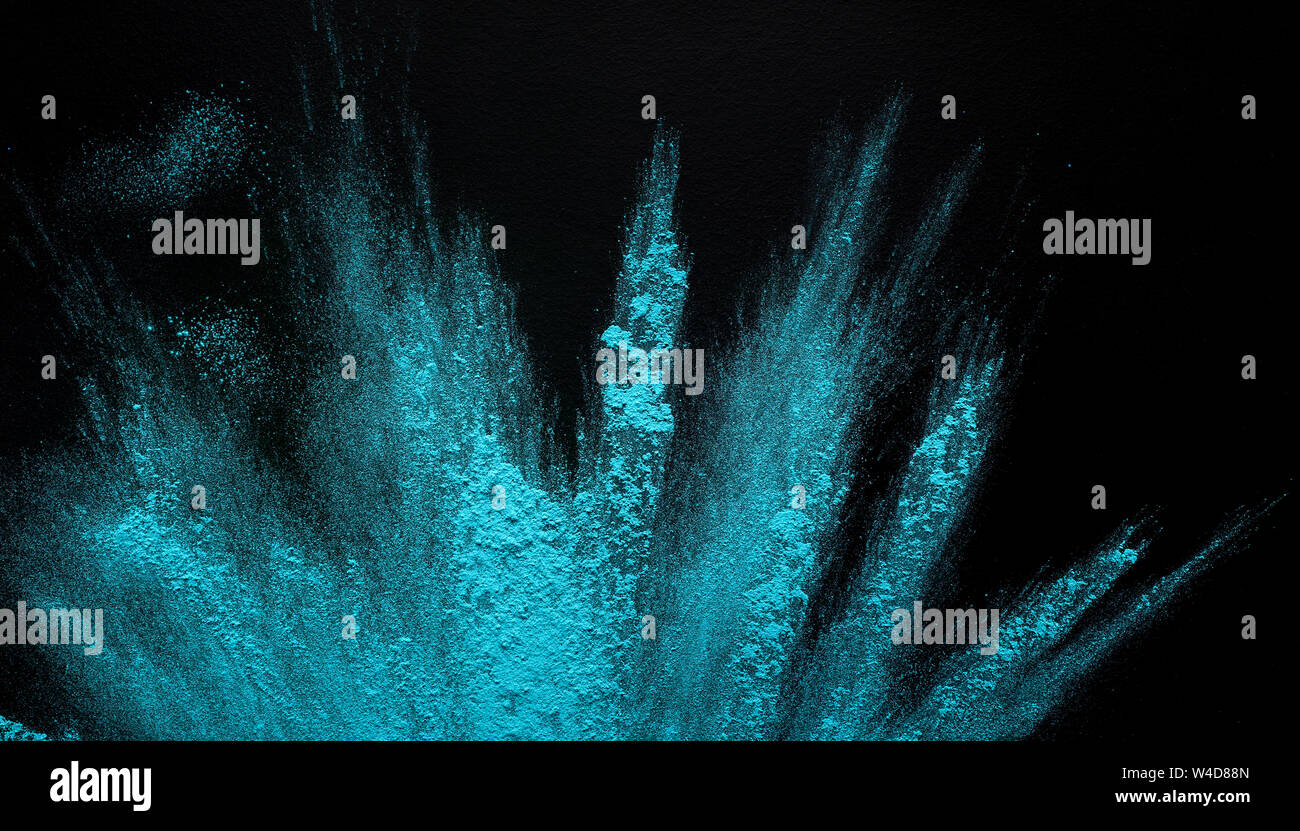 Freeze motion of blue powder throwing on black background Stock Photo ...