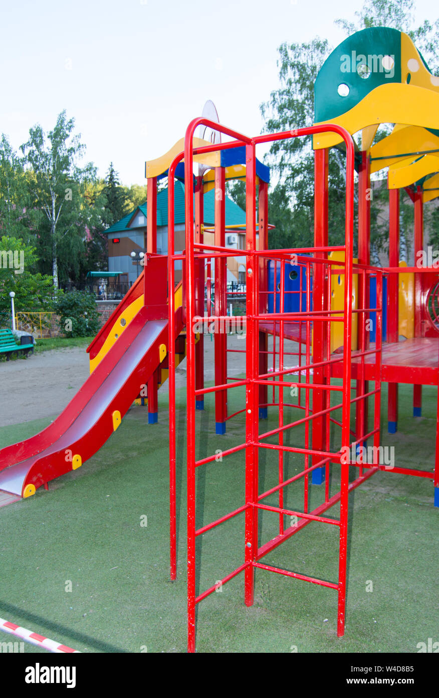 Colorful children's Playground with slides and swings outdoors in the ...