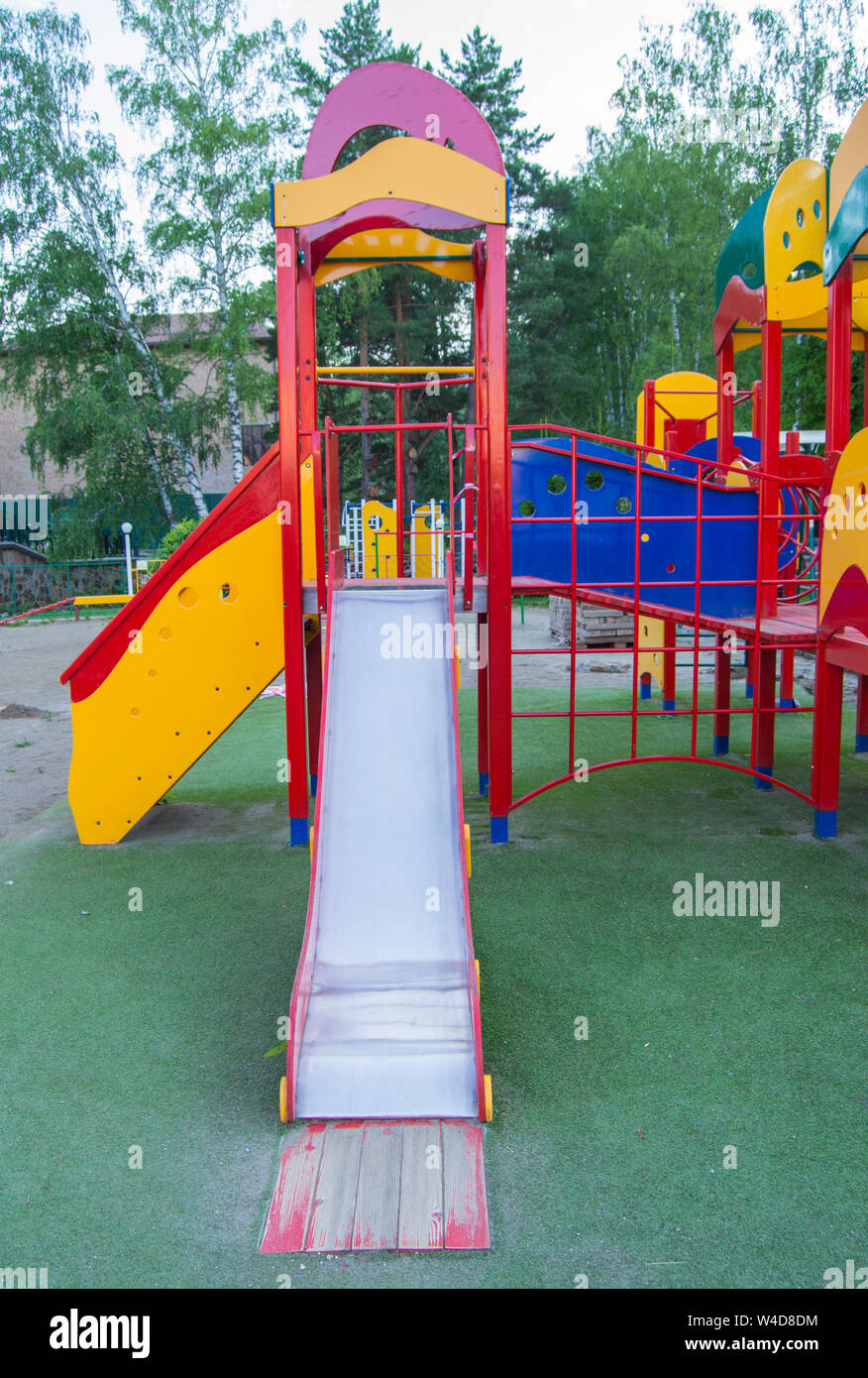 Colorful children's Playground with slides and swings outdoors in the ...