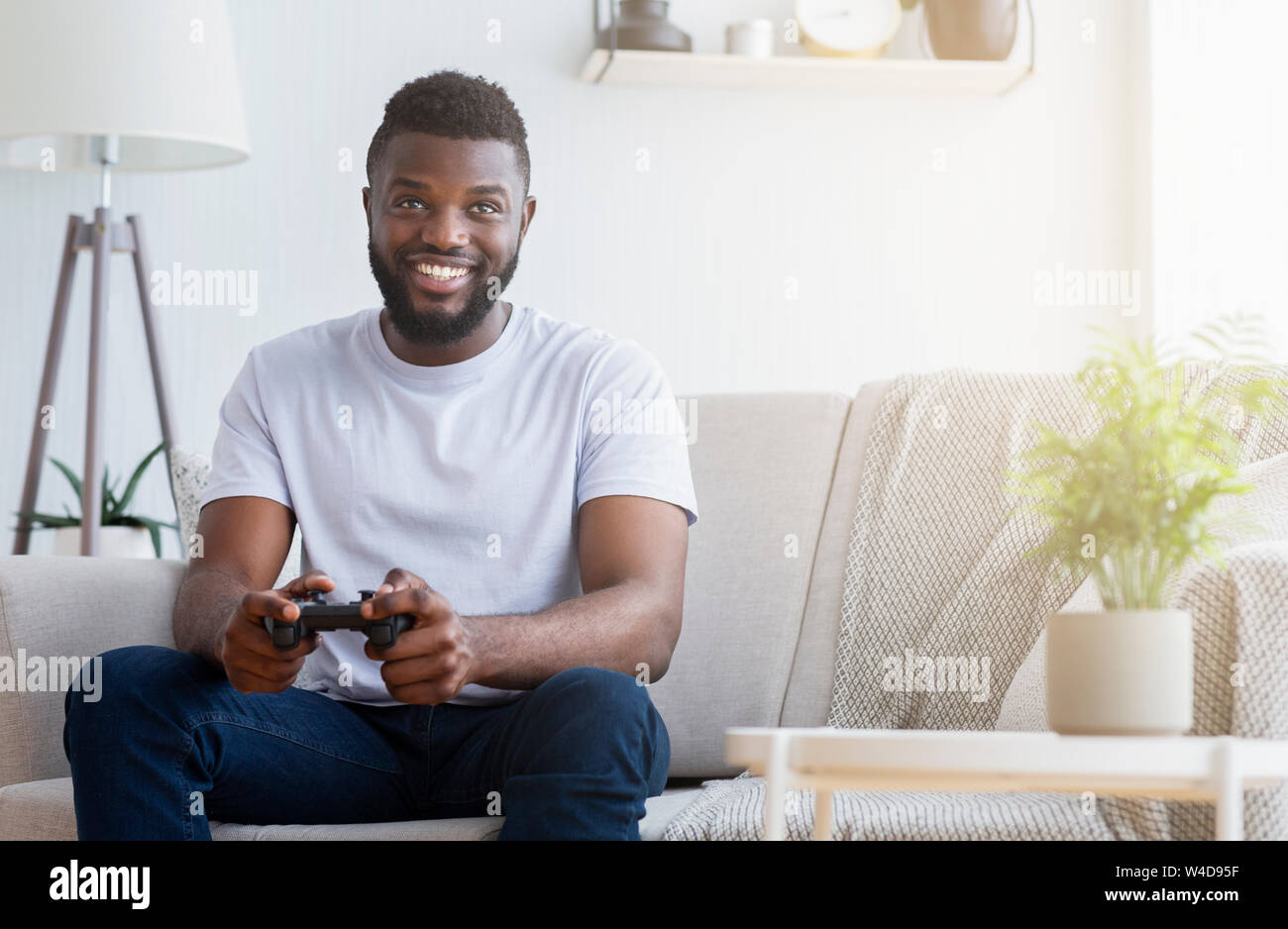 Young man playing video games at home Stock Photo - Alamy