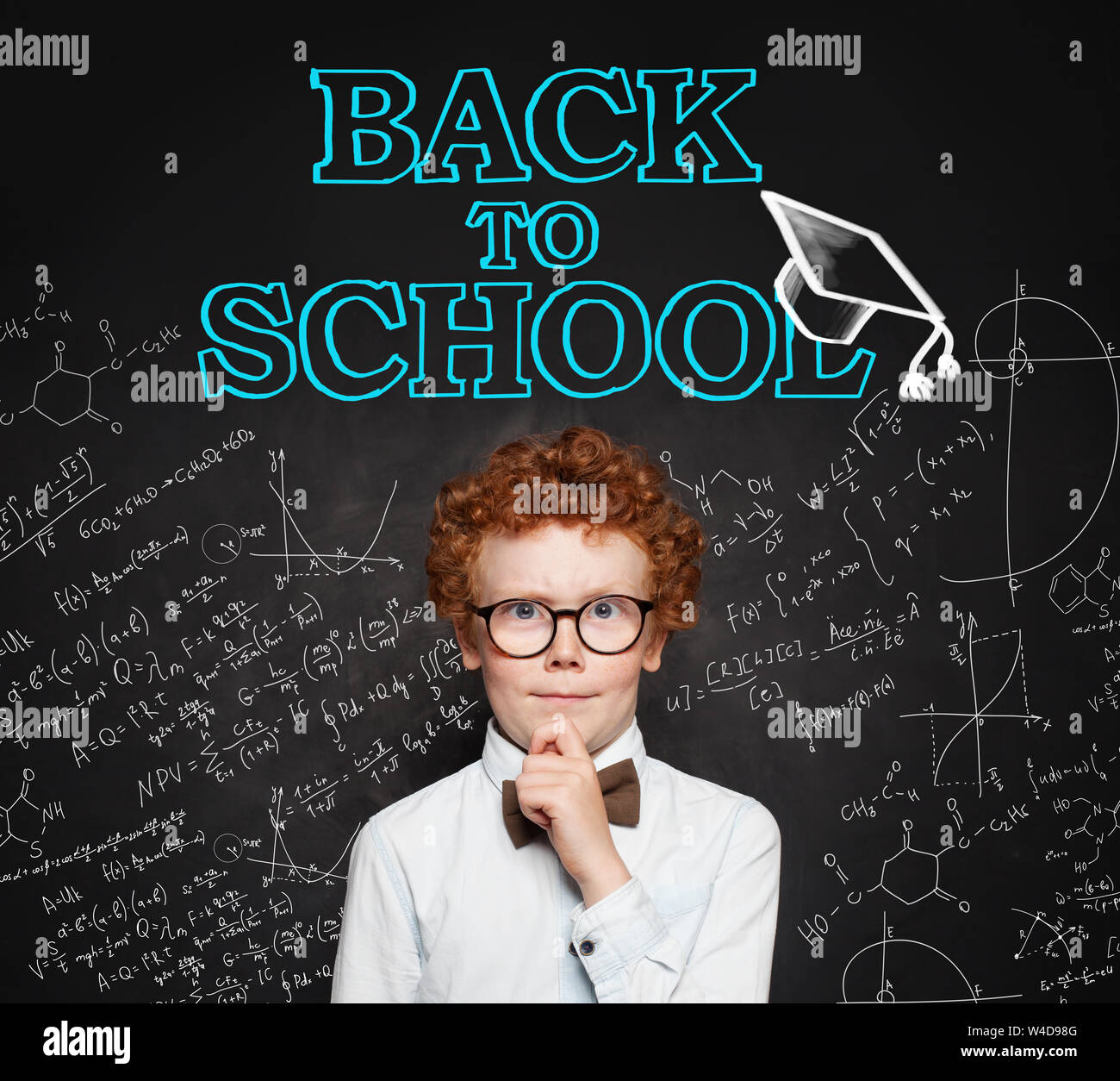 Redhead child thinking on chalkboard. Back to school background Stock ...