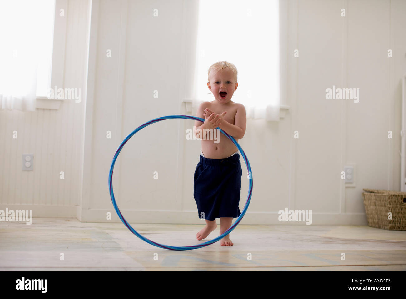Toddler with a hula hoop Stock Photo - Alamy