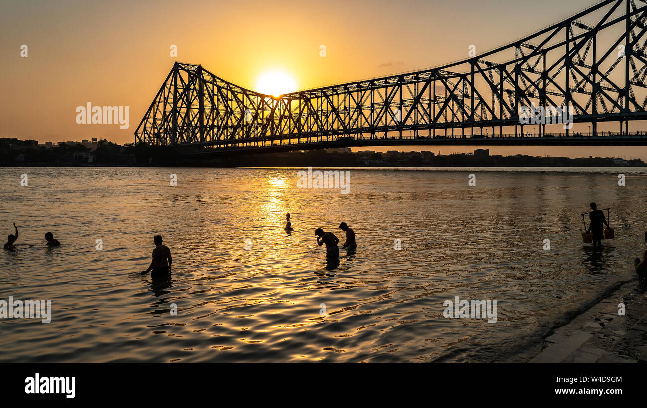 Silhouette of Howrah Bridge at the time of Sunrise. Howrah Bridge is a ...