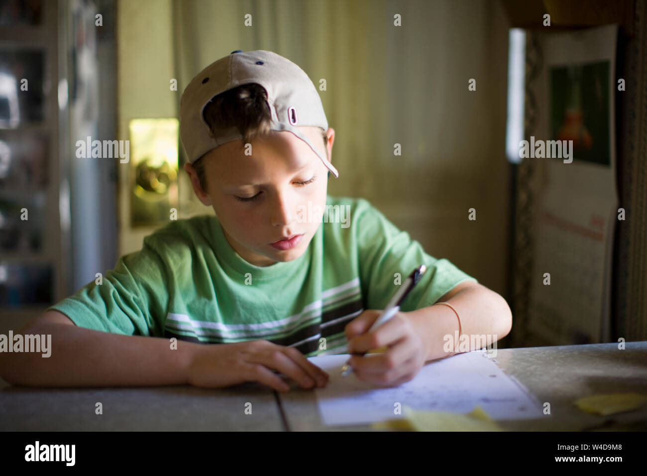Young boy writing Stock Photo - Alamy
