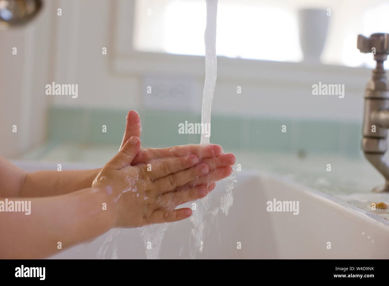 Child washing hands under tap Stock Photo - Alamy
