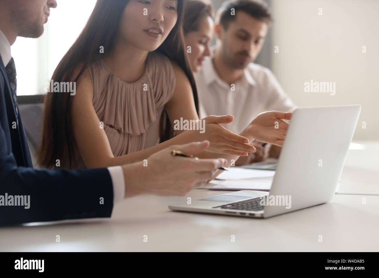 Business discussion, asian employee talking to colleague pointing at ...