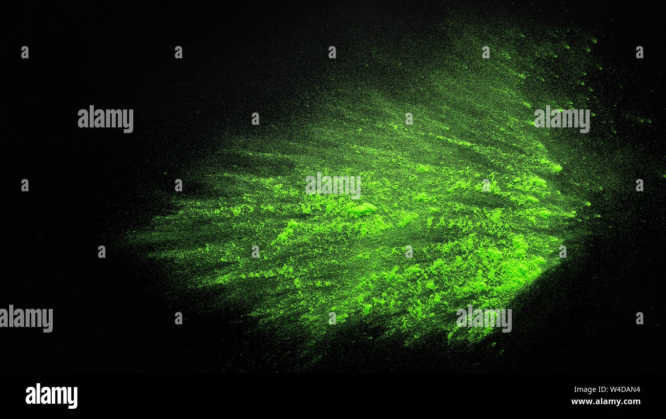 Light green holi powder splatted on black background Stock Photo - Alamy