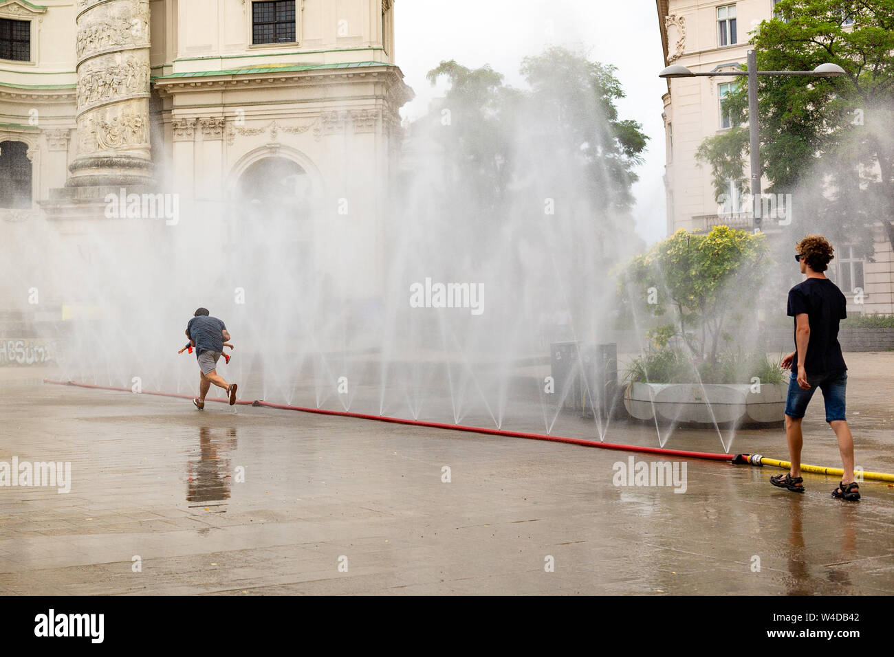 Vienna, Austria - Juli 21, 2019. Water mist and shower spray of water ...