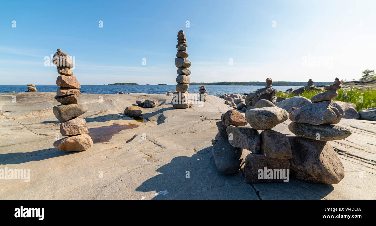 Stacked Rocks balancing, stacking with precision. Stone tower on the ...