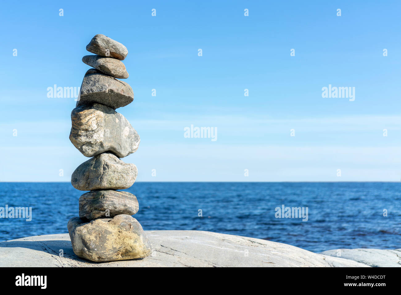 Stacked Rocks balancing, stacking with precision. Stone tower on the ...
