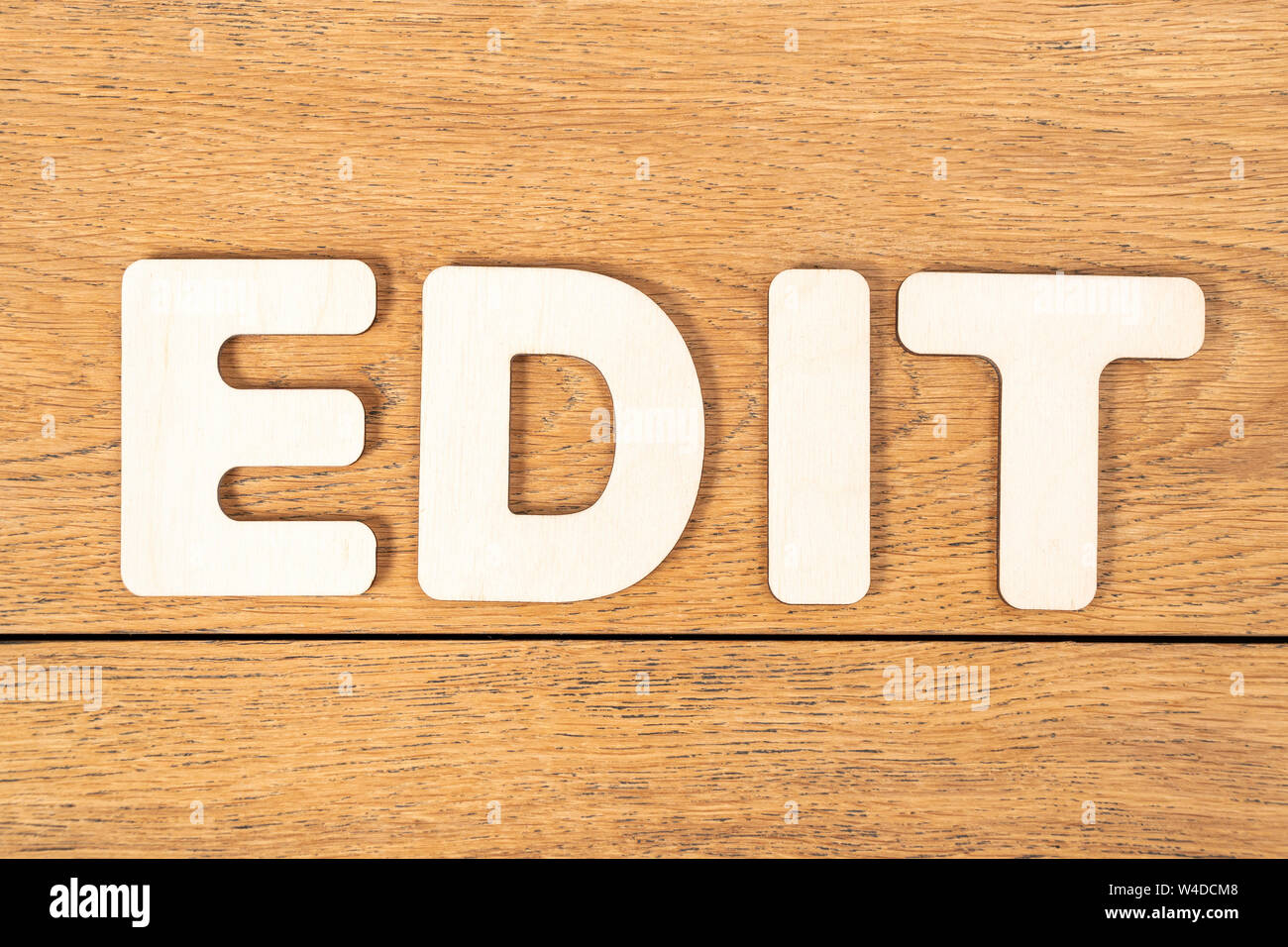 Word - edit, laid out in wooden letters on an old wooden table Stock ...