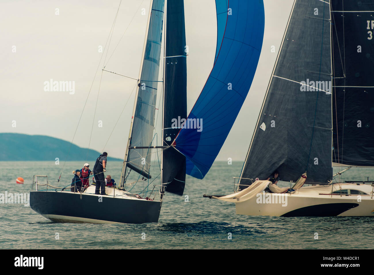 Sailing together. Collision course. Two sailboats sails close to each ...
