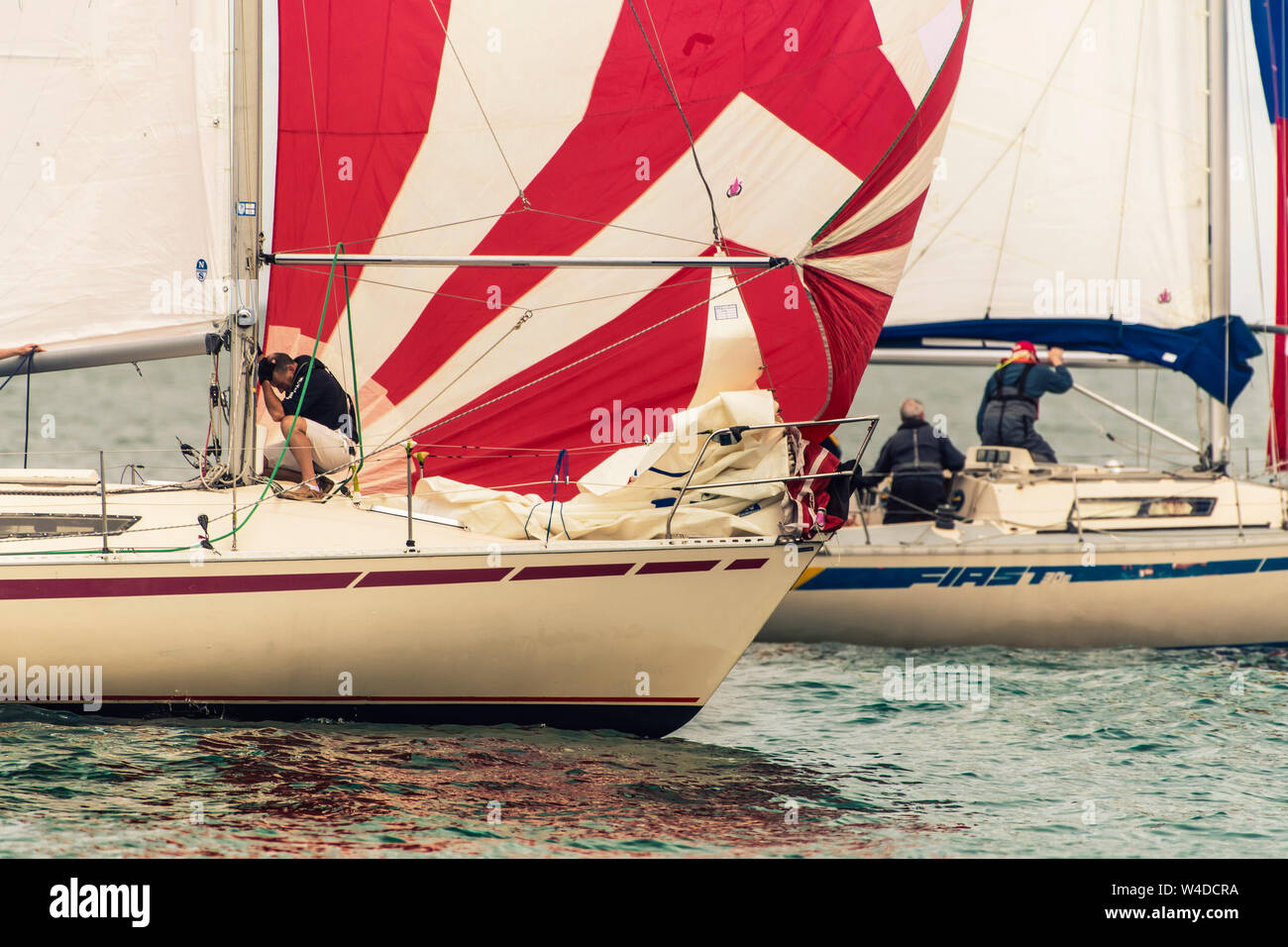 Upset. Depressed yachtsman sitting on a deck after finishing the race ...