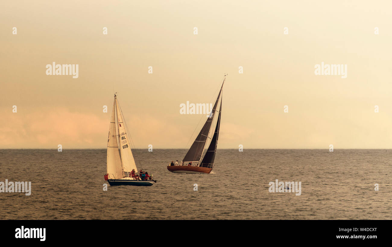Sailing together. Group of sailboats sails on the edge of horizon ...