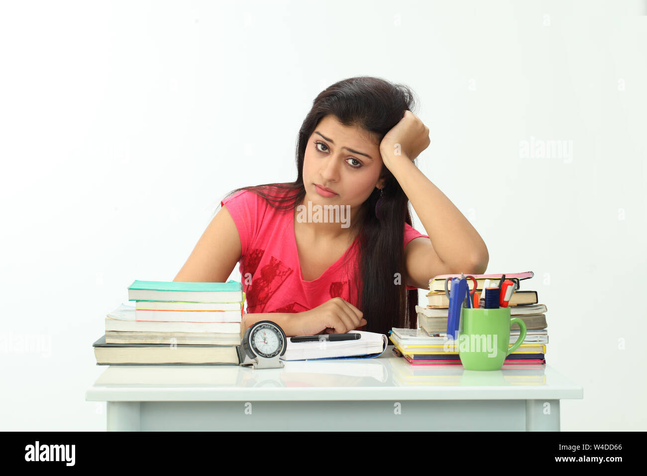 Indian college student looking tired while studying Stock Photo - Alamy