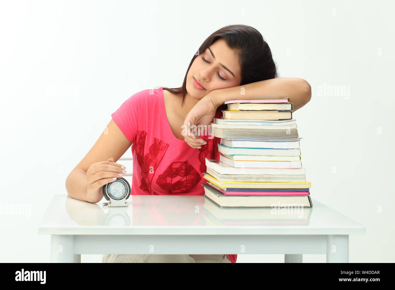 College student sleeping on stack of books in a classroom Stock Photo ...