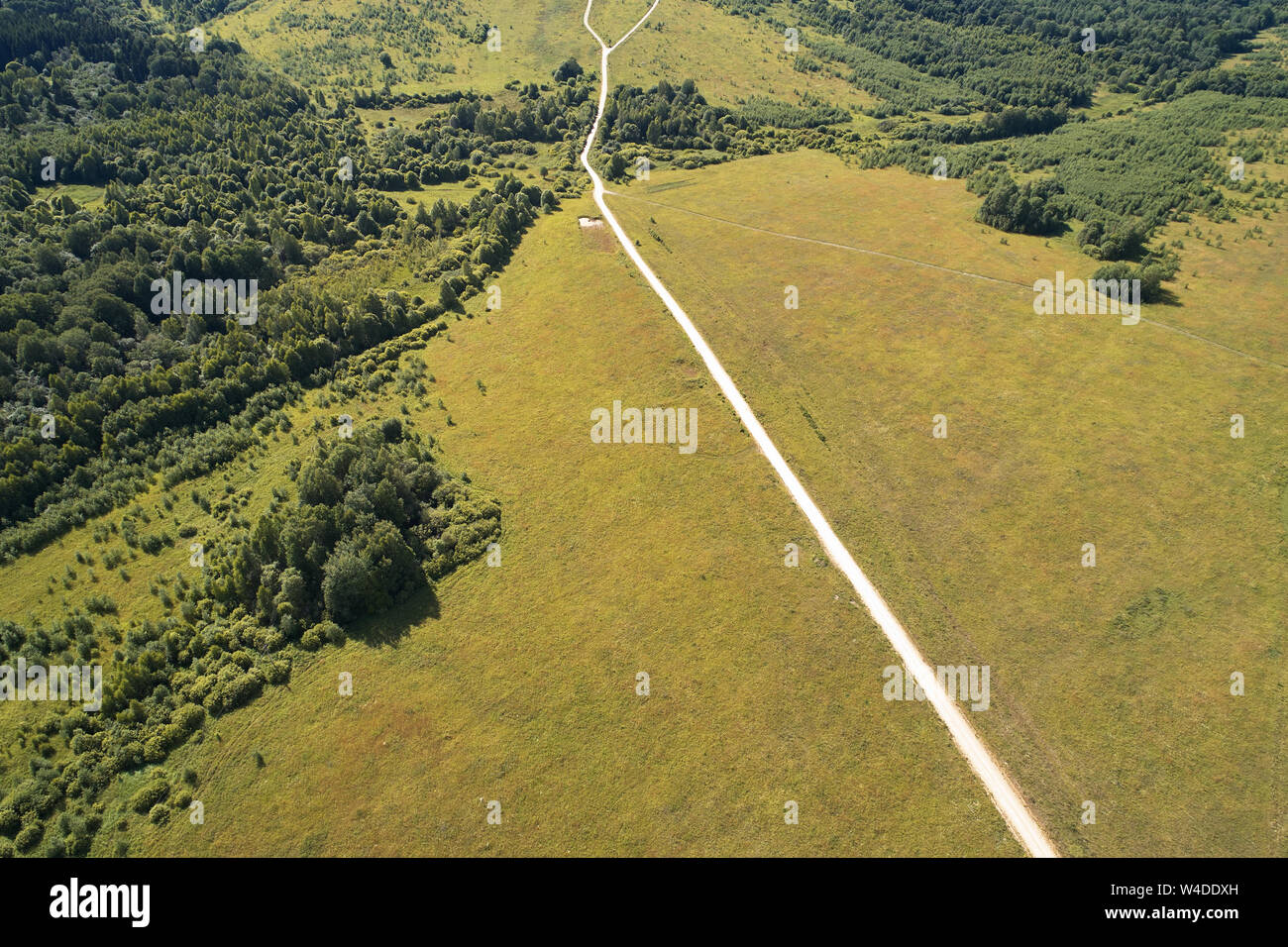 Aerial photography with a drone. Straight dirt road running through the ...