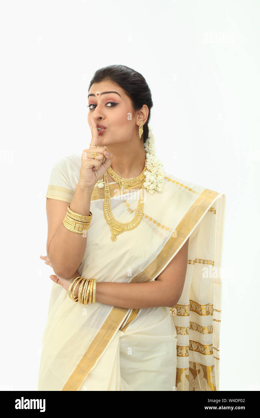 Portrait of a south Indian woman with a finger on lips Stock Photo - Alamy