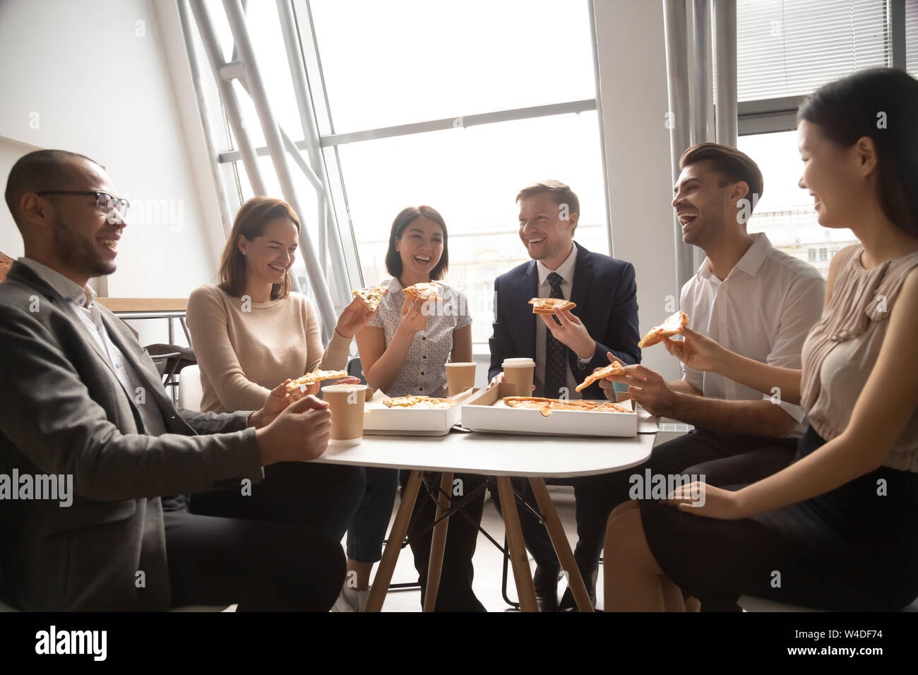Happy Multicultural Staff Workers Business Team Having Fun Eating Pizza