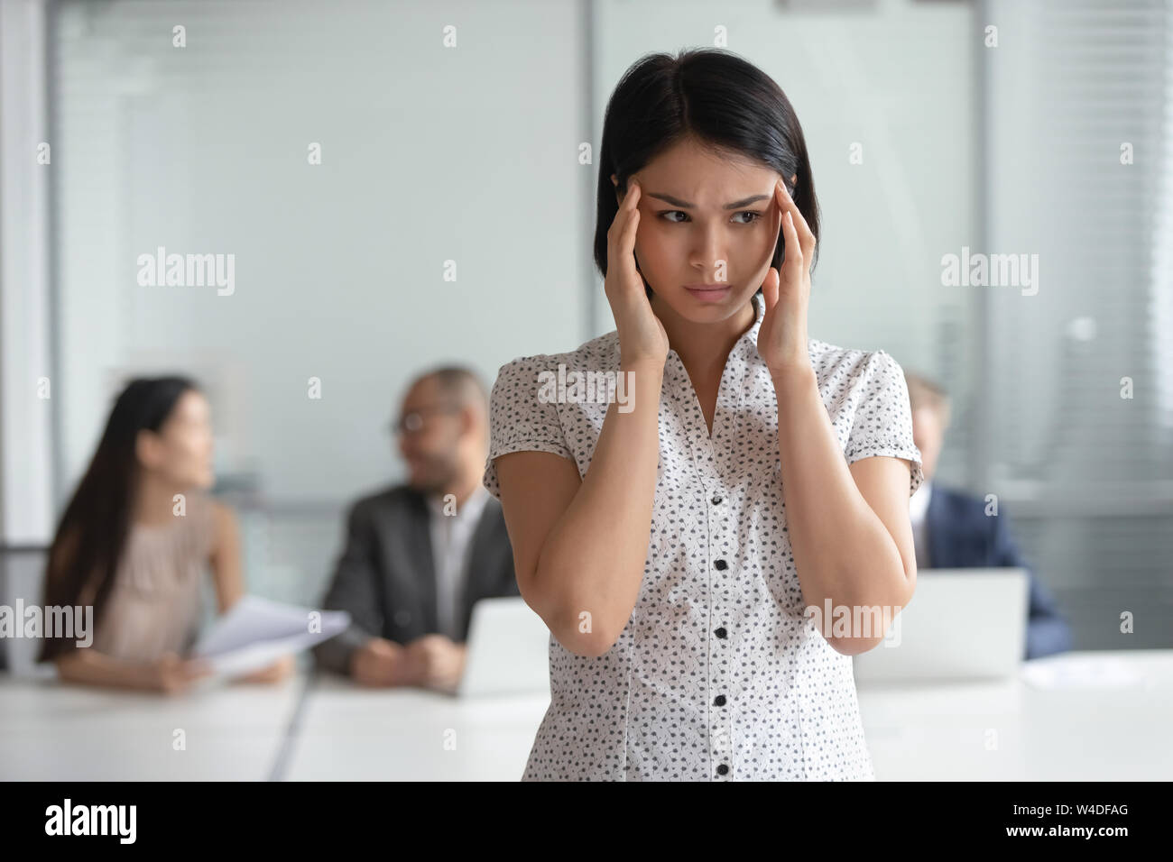 Stressed nervous asian business woman employee feel headache at work ...