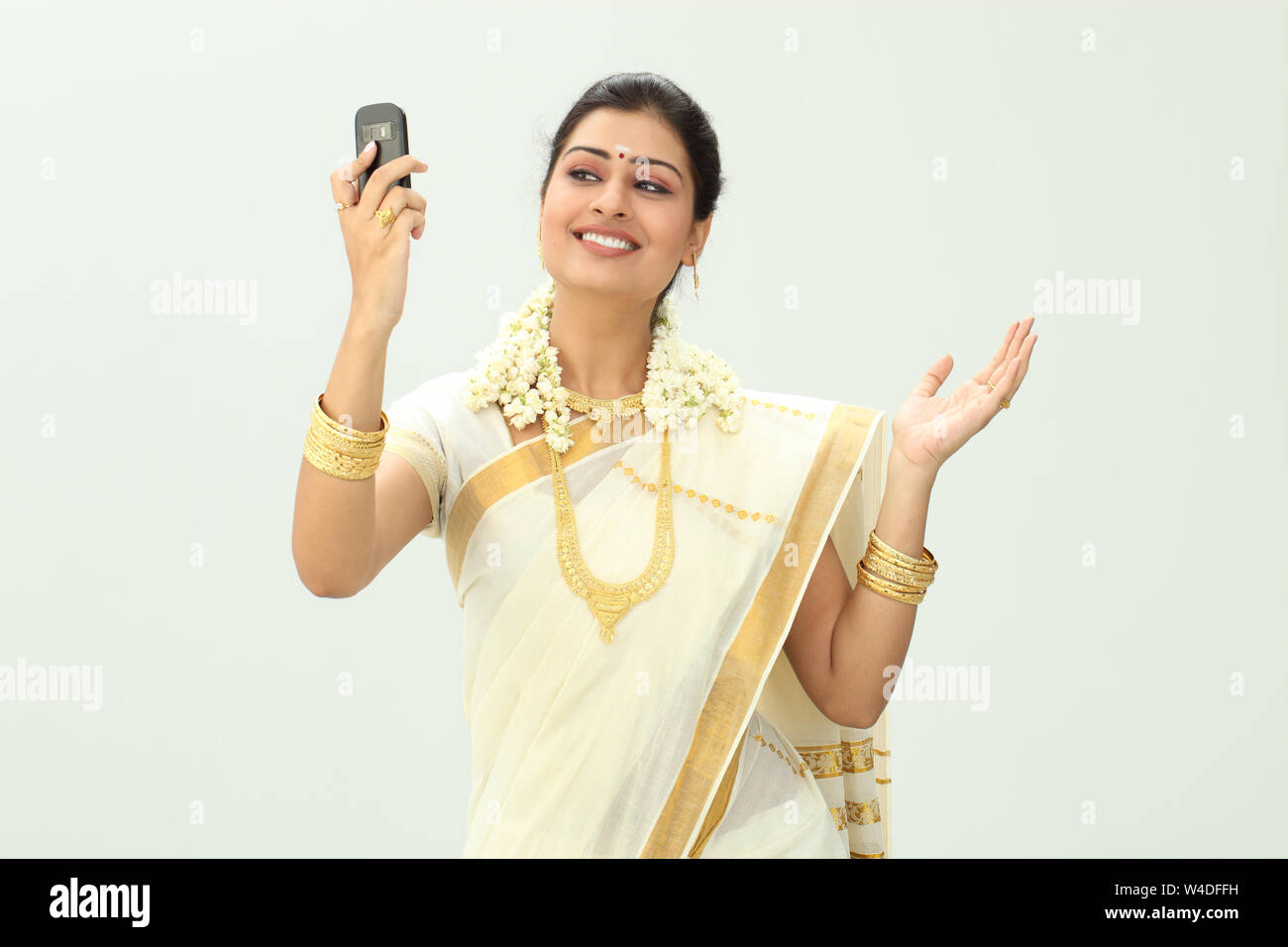 South Indian woman text messaging and smiling Stock Photo - Alamy