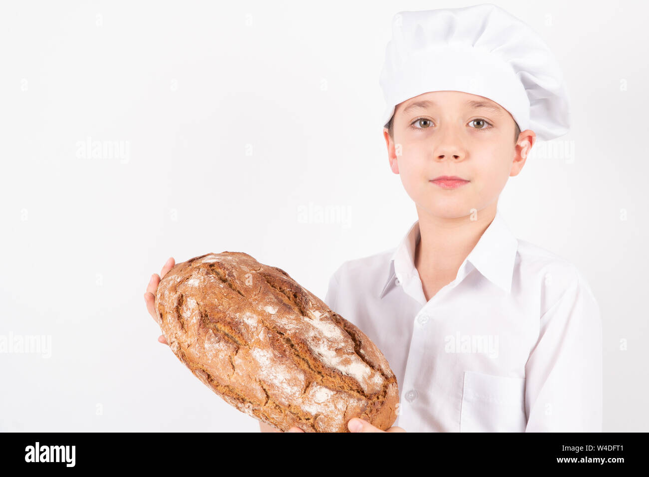 Cook Boy With rustic Bread on white background Stock Photo - Alamy