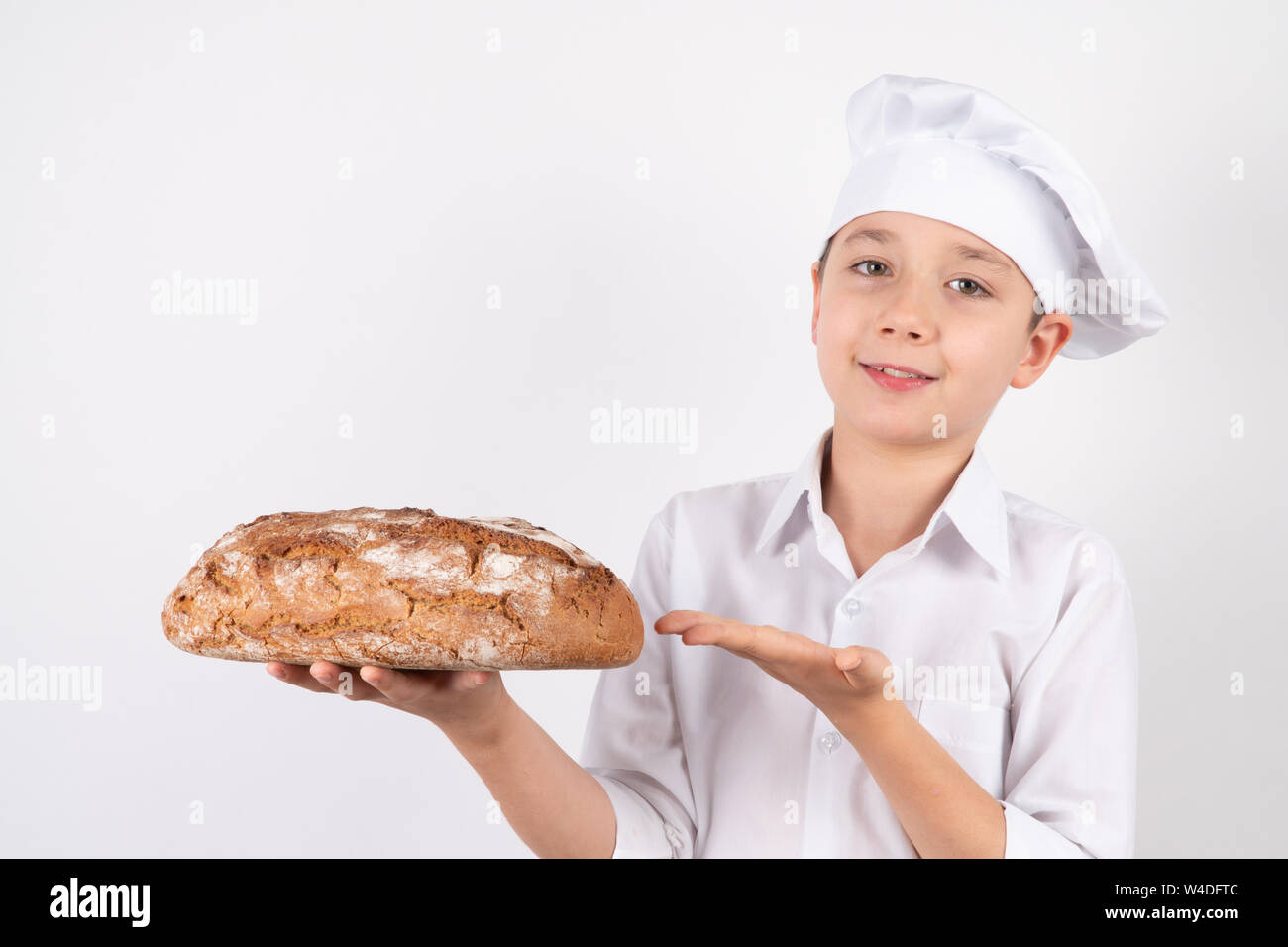 Cook Boy With rustic Bread on white background Stock Photo - Alamy