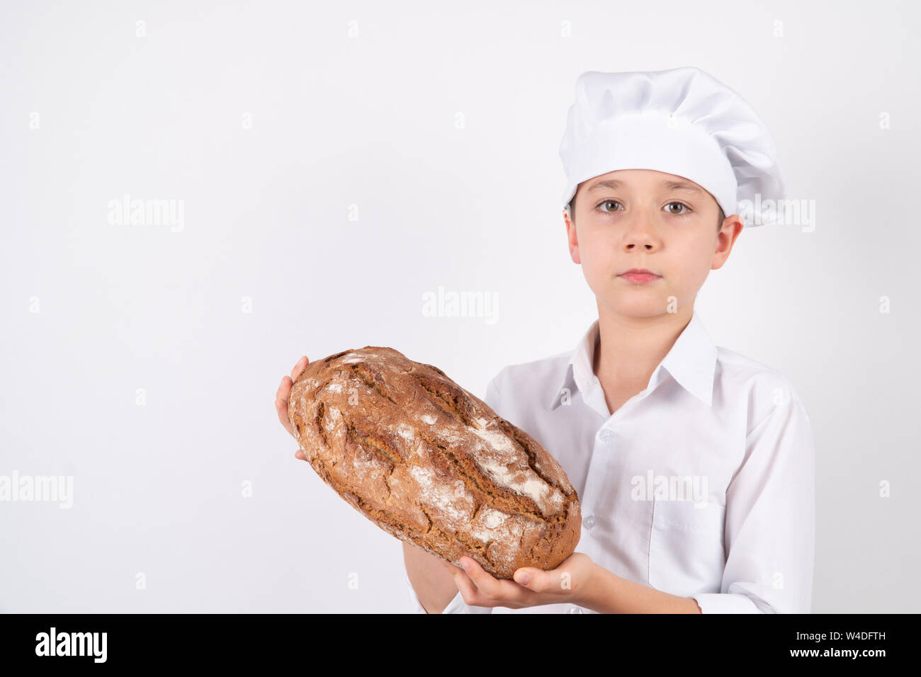 Cook Boy With rustic Bread on white background Stock Photo - Alamy