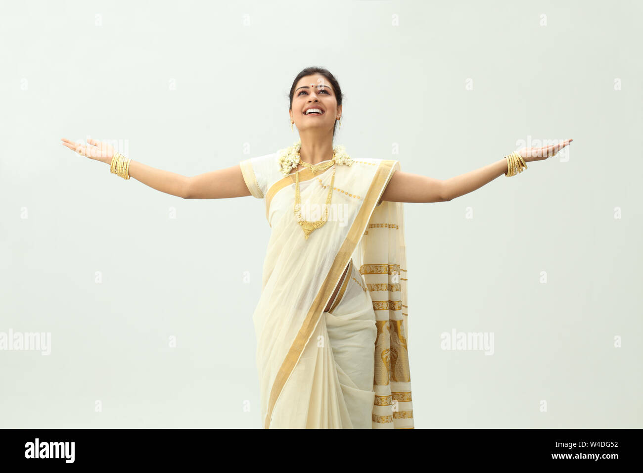 South Indian woman standing with her arm outstretched Stock Photo - Alamy