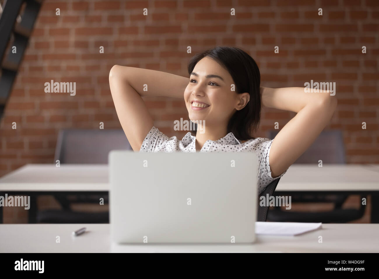 Relaxed smiling asian businesswoman take break to rest at workplace ...